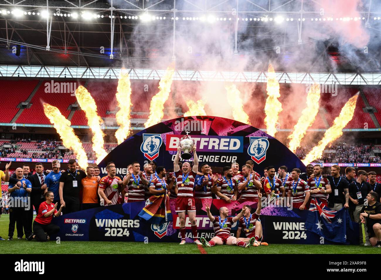 Liam Farrell of Wigan Warriors lifts the Betfred Challenge Cup after ...