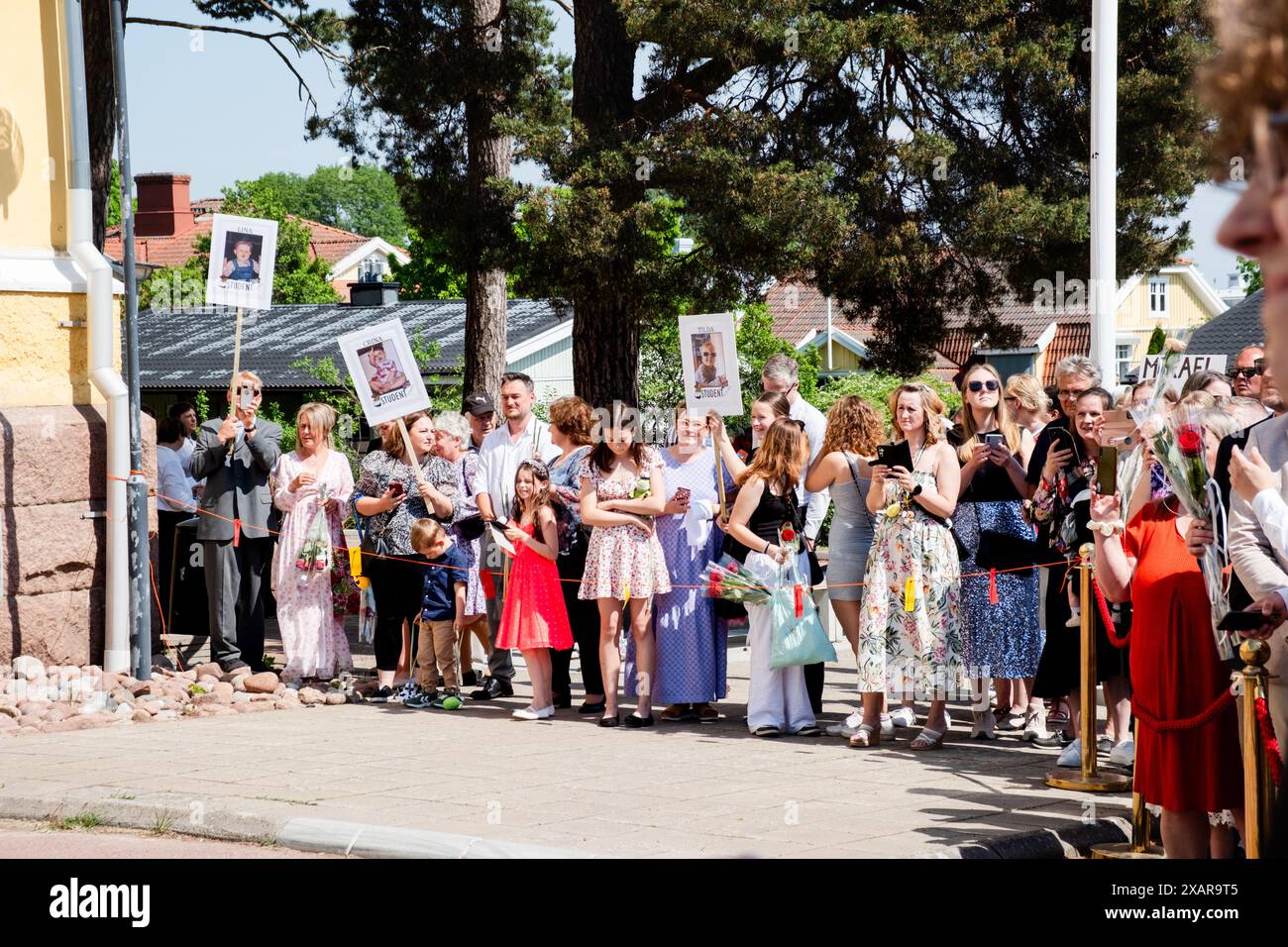 It's a sea of placards and mobile phones as friends and families gather ...