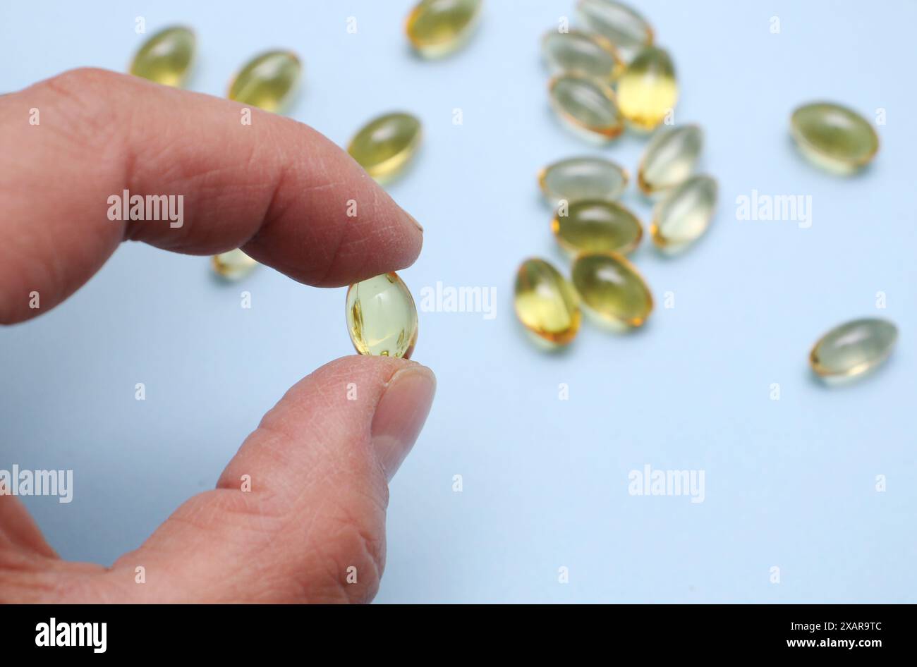 Hand holding pill between finger hi-res stock photography and images ...