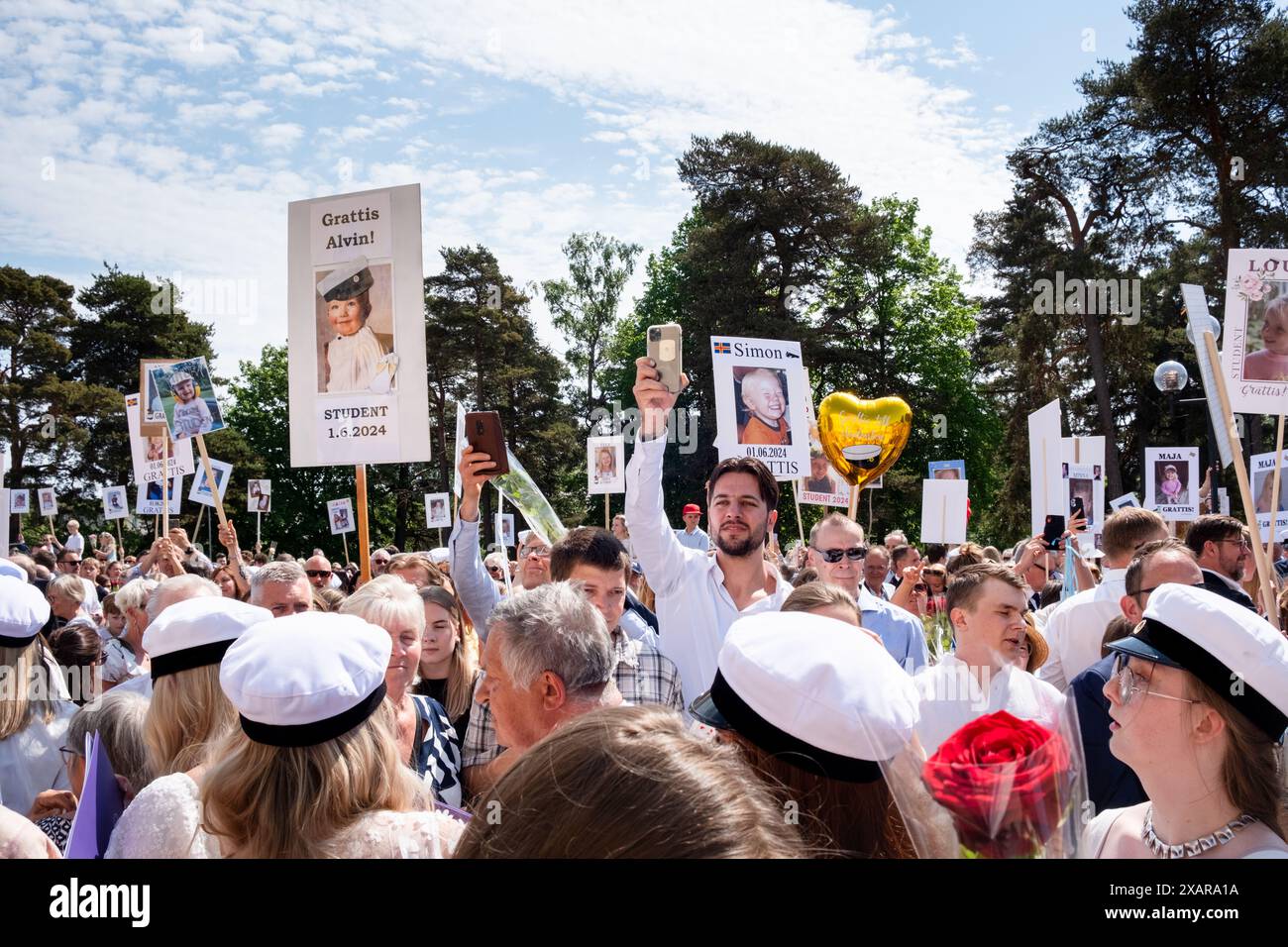 It's a sea of placards and mobile phones as friends and families gather ...