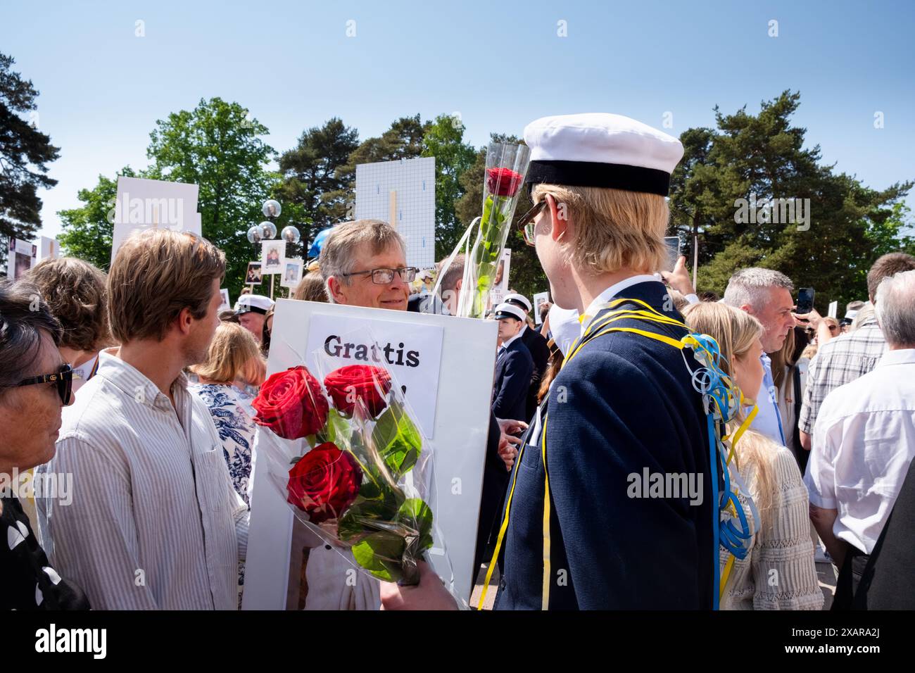 It's a sea of placards and roses as friends and families gather outside ...