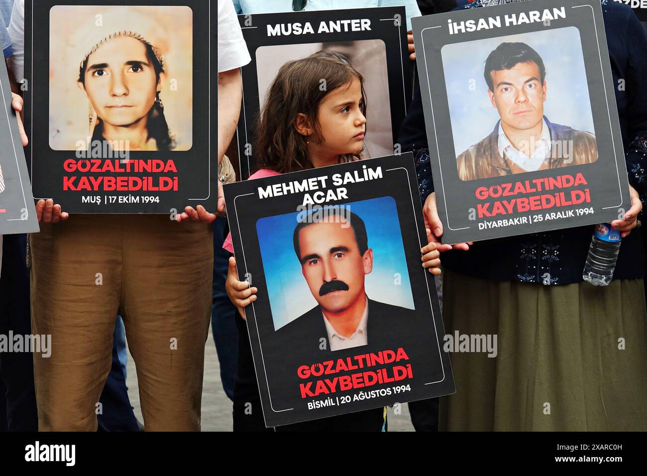 A girl seen carrying a photo of a missing relative during the protest ...
