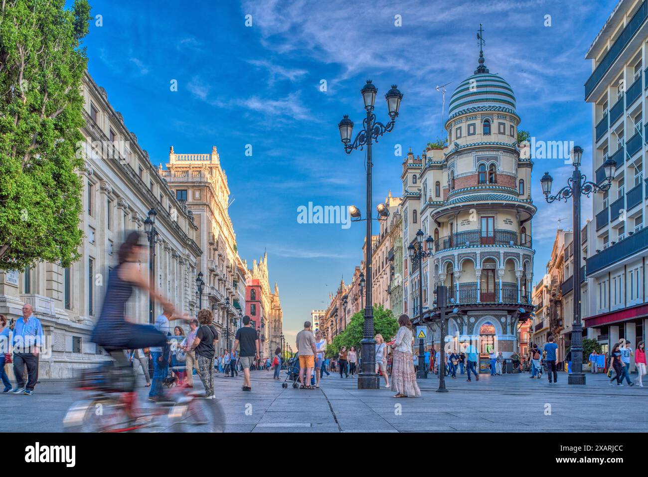 A bustling street scene on Avenida de la Constitucion in Seville, Spain ...