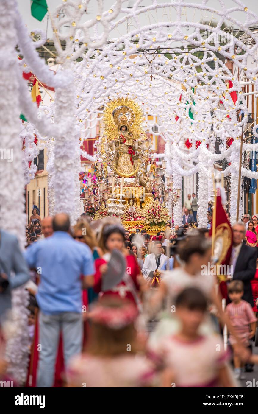 Catholic devotees carry the Virgen del Rosario statue under decorative ...