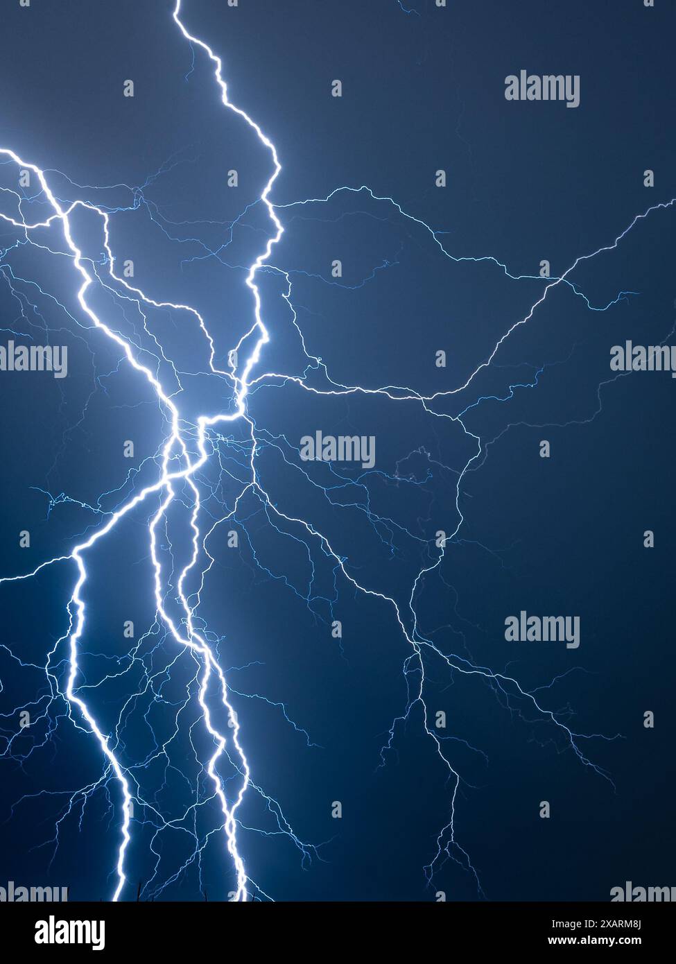 Bright forked lightning during a thunderstorm at night. Suitable as ...