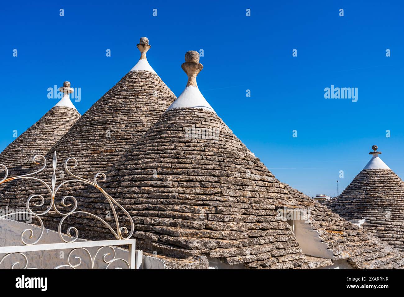 Conical roofs of the famous old dry stone trulli houses in Alberobello ...