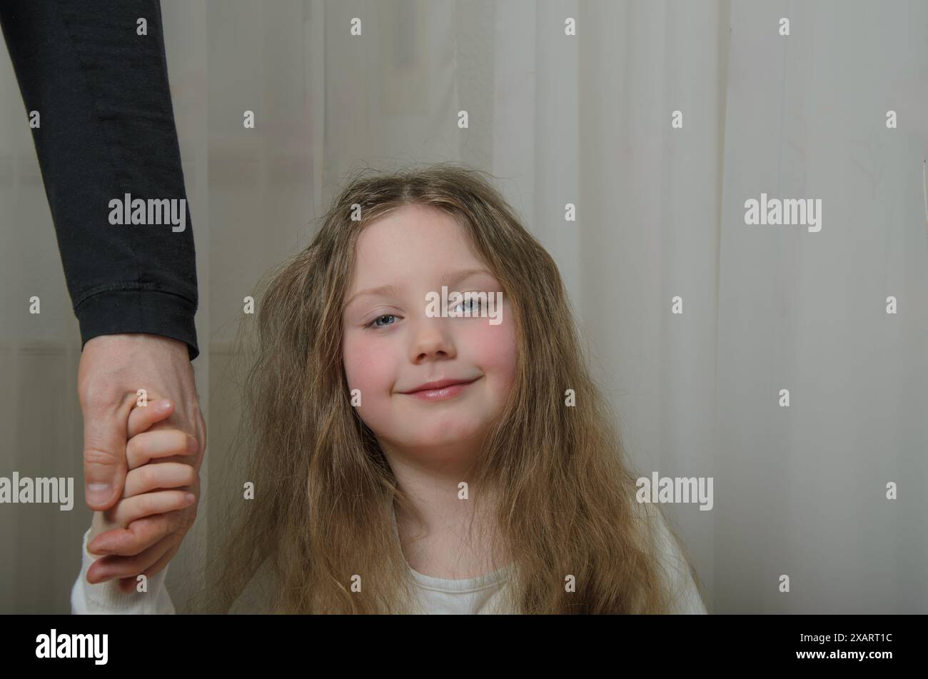 A little girl is holding the hand of an adult. man. fater Stock Photo ...