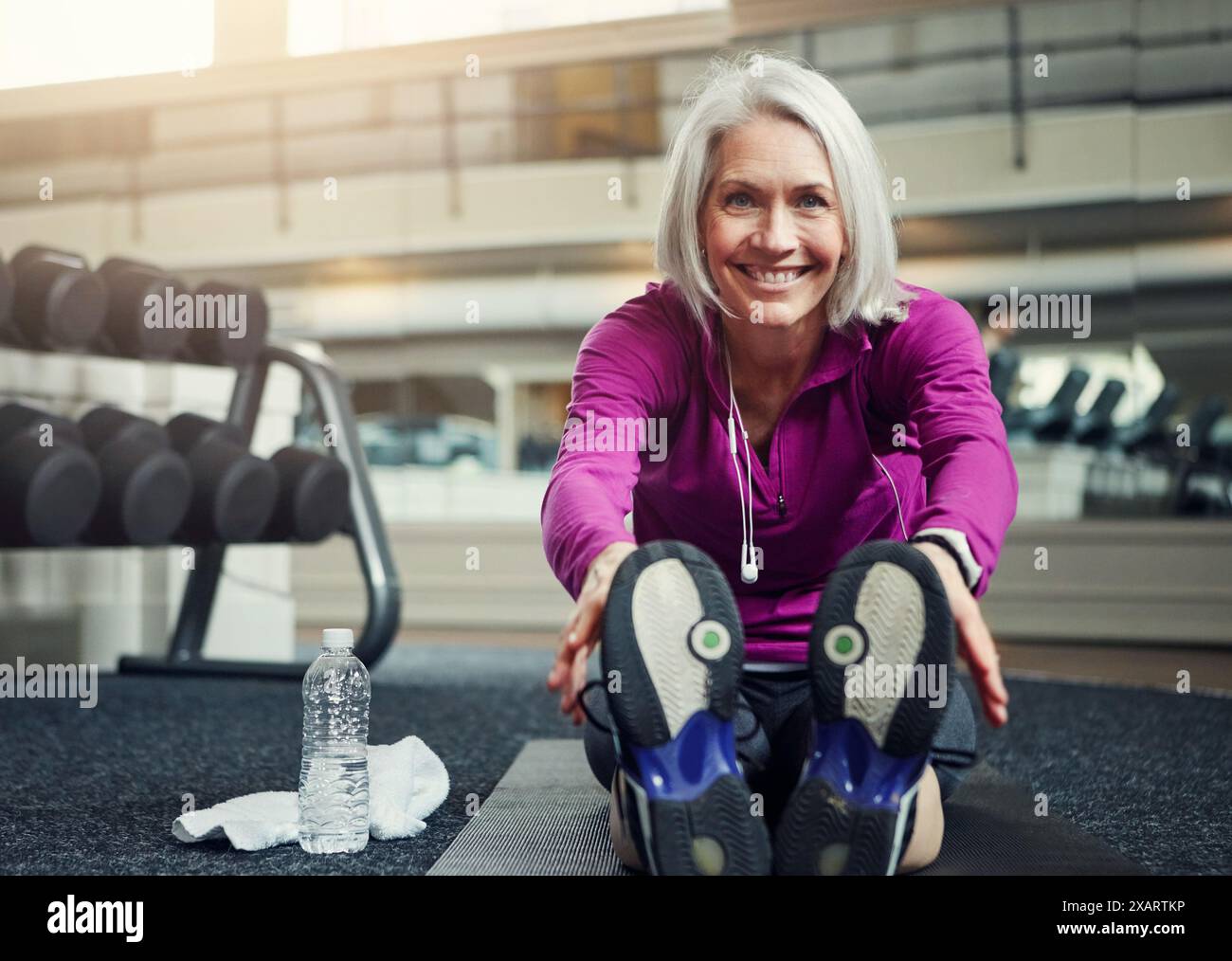 Feet, portrait or mature fitness woman stretching on gym floor for ...