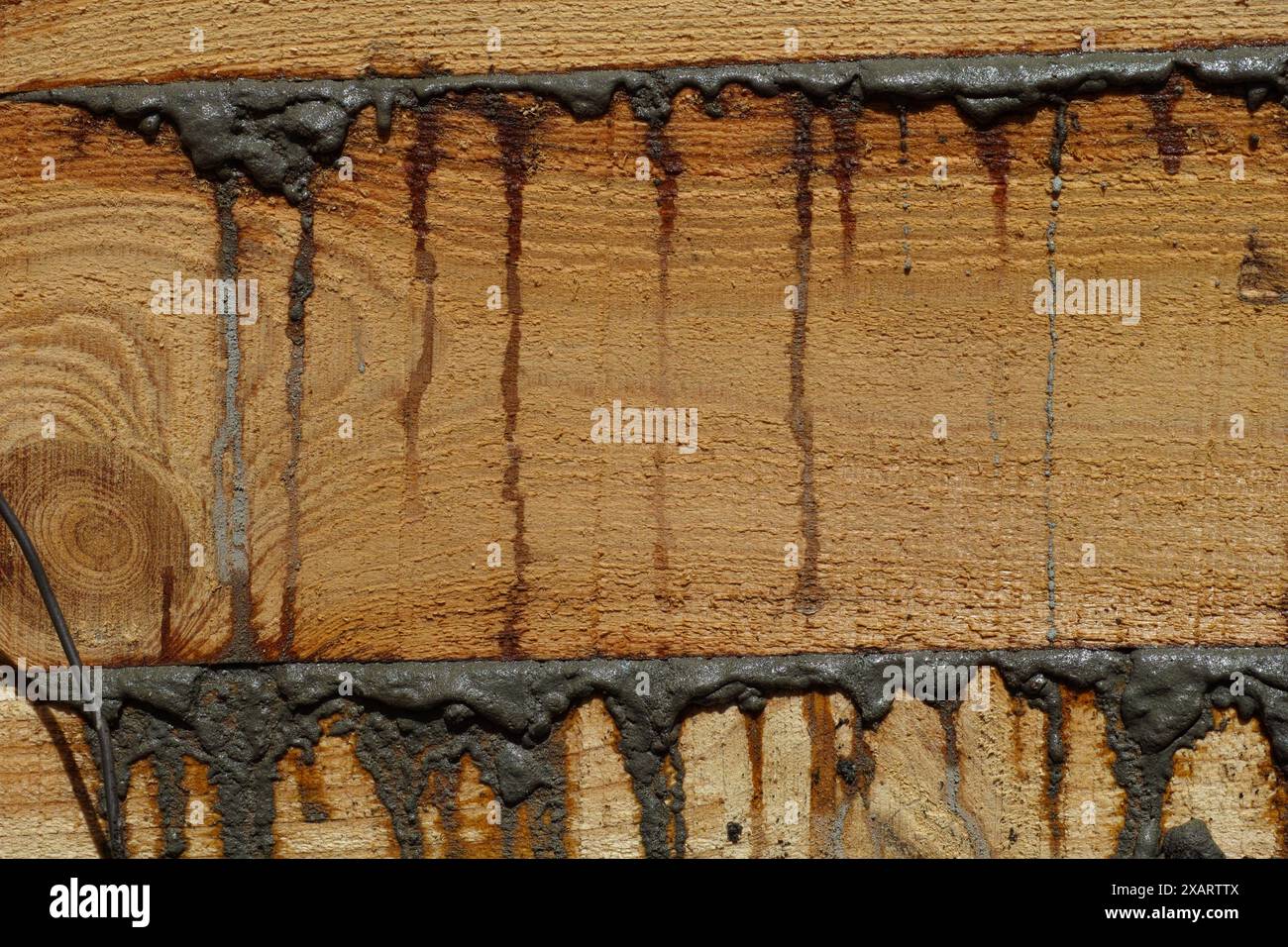 Wooden formwork with wet cement leaking from it. Close-up Stock Photo ...