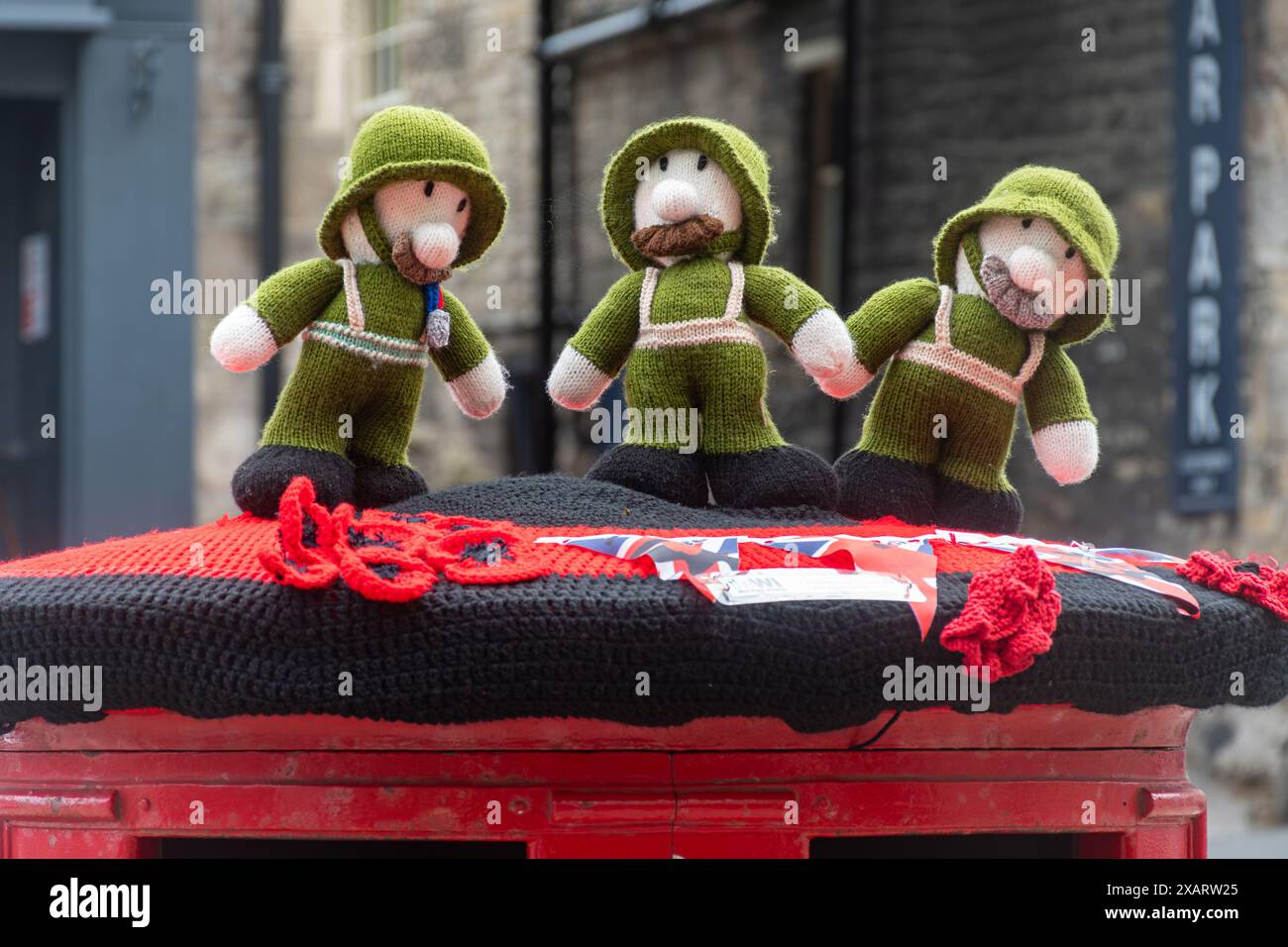 Yarn bombed letterbox with knitted soldier characters on top to ...