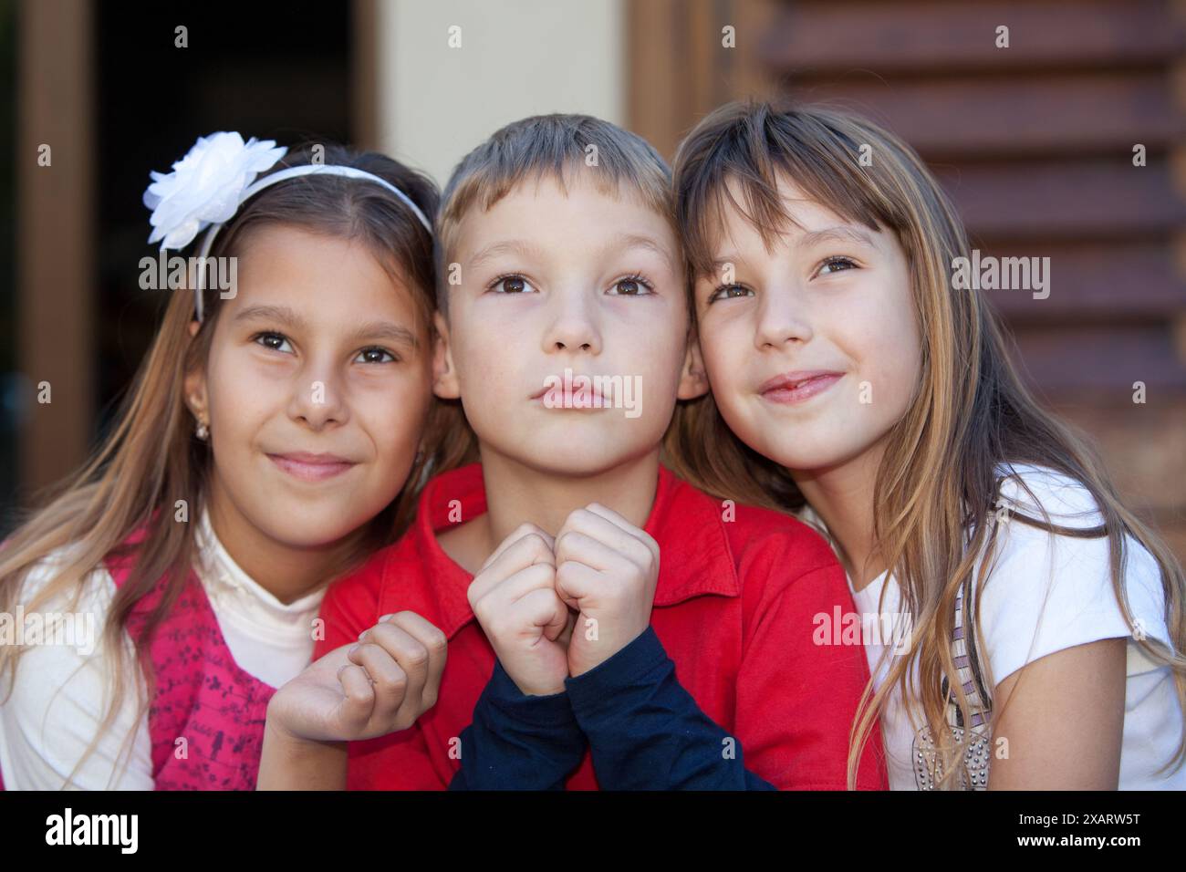 portrait of three cute children looking up Stock Photo - Alamy