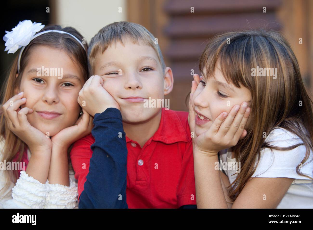 portrait of three happy children daydreaming Stock Photo - Alamy