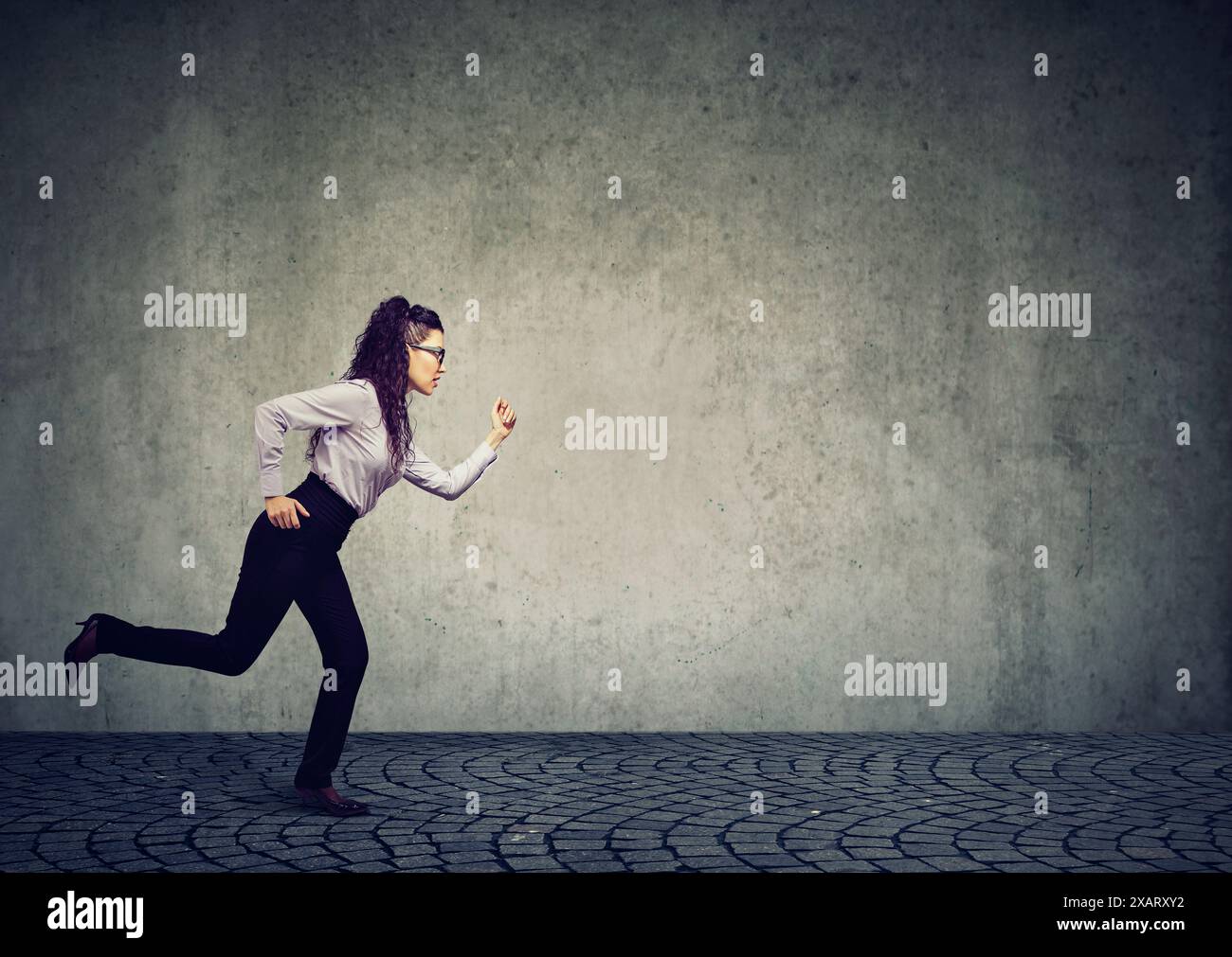 Businesswoman running forward under time pressure willing to achieve ...