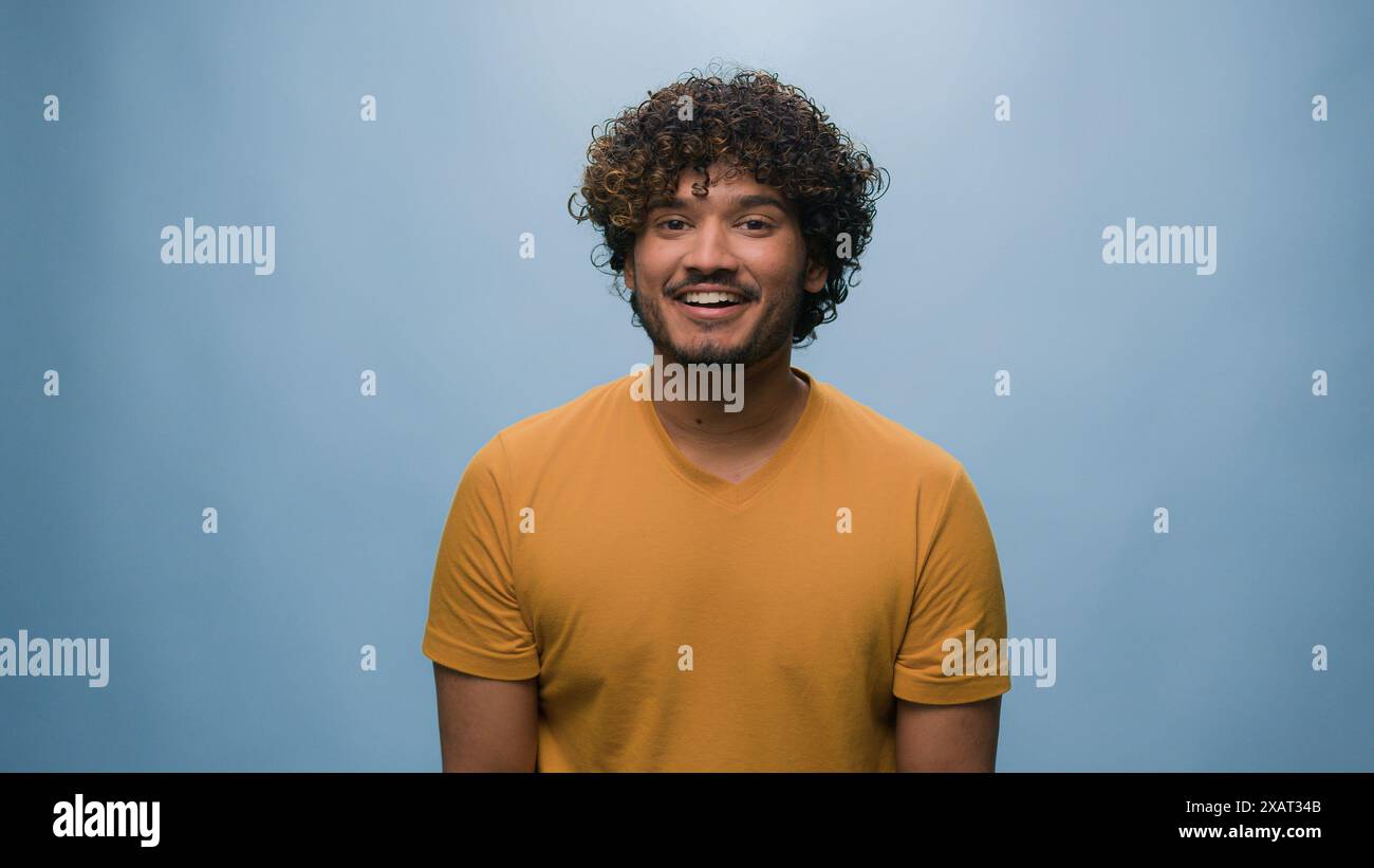 Studio portrait happy Arabian man Indian guy Hispanic male put on ...