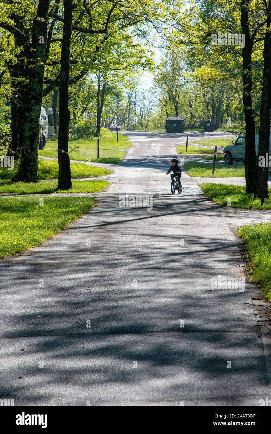Single male child riding a bicycle n the early morning around a ...