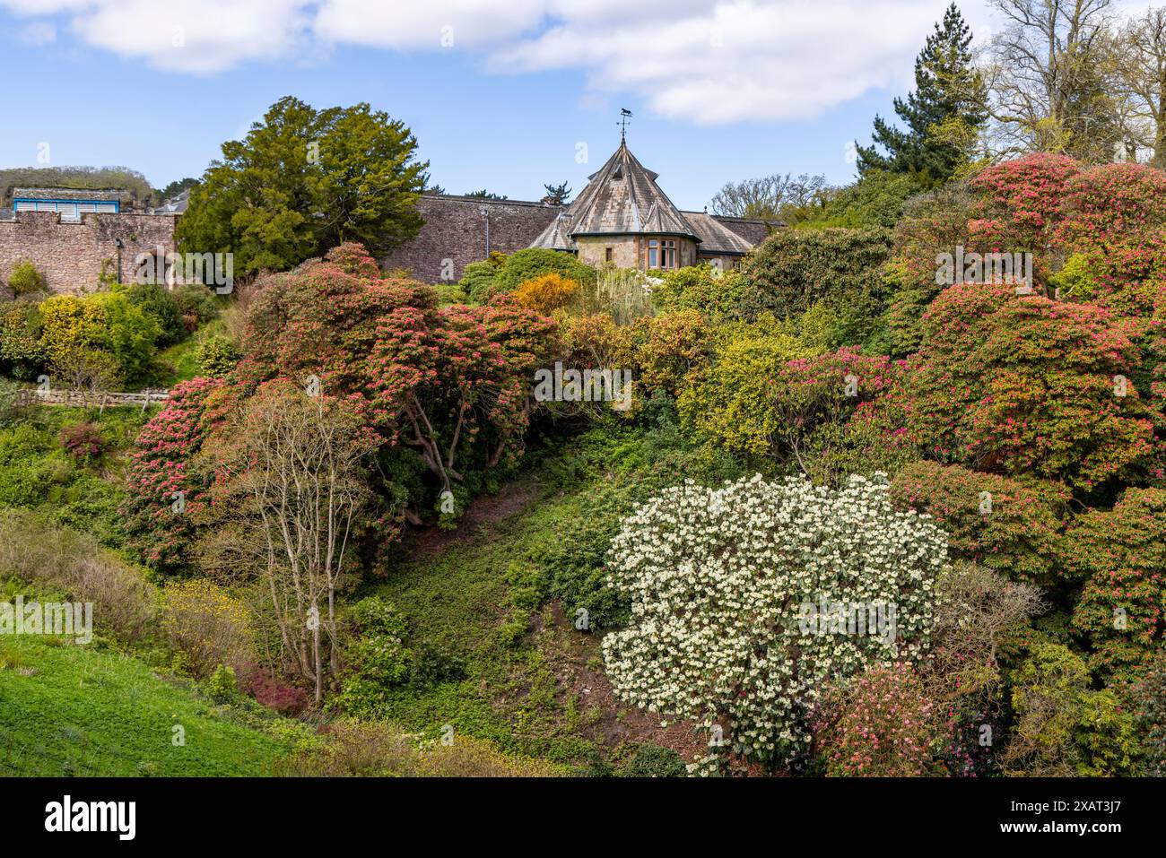 View of the gardens from Muncaster Castle, a Medieval castle, home of ...