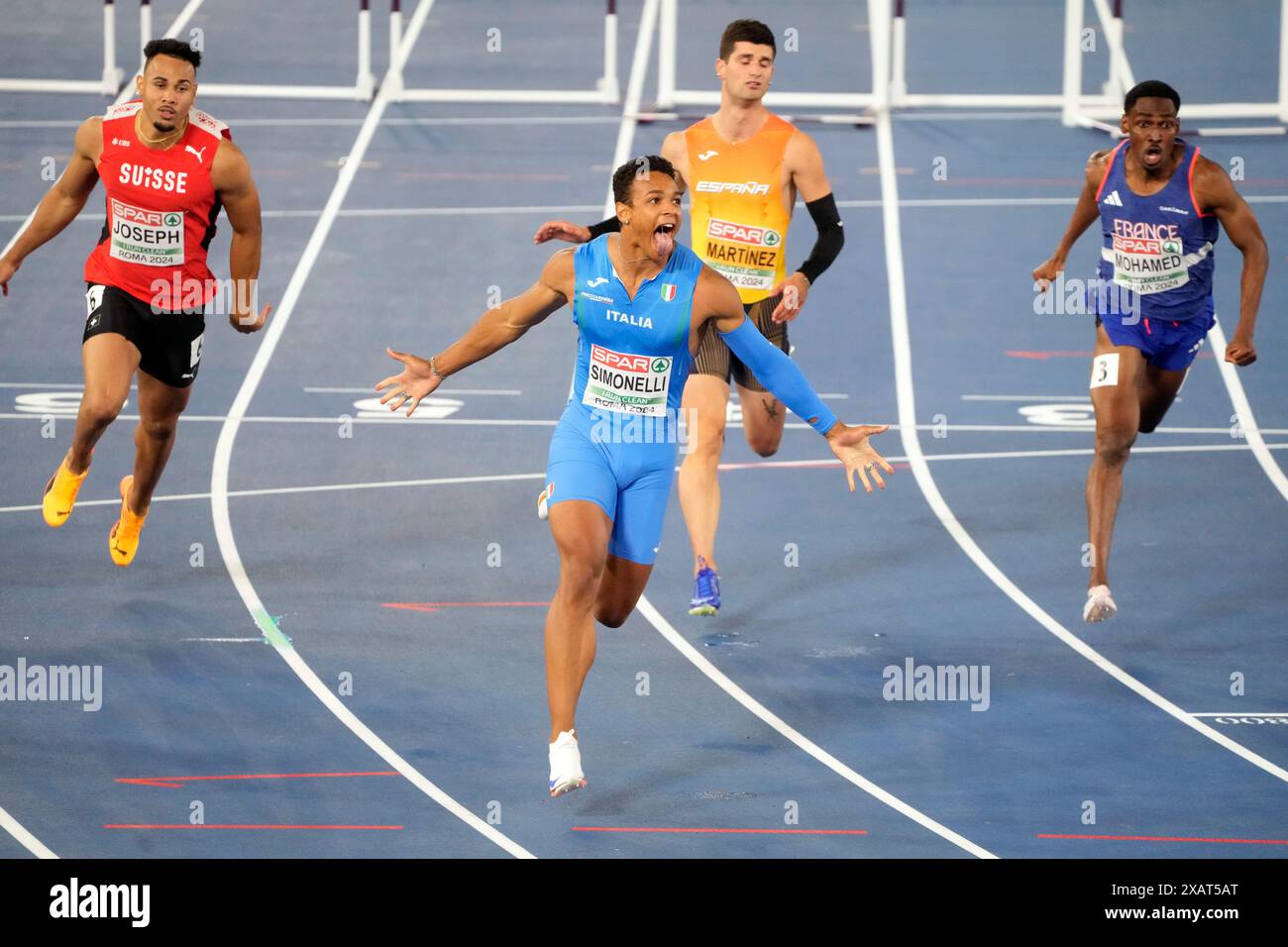 Lorenzo Simonelli, of Italy, center, crosses the finish line to win the ...