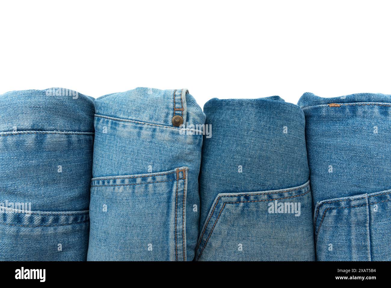 Stack of different jeans on a white background. Denim background ...