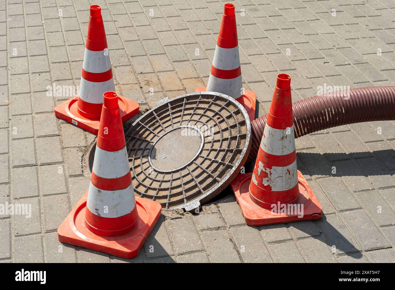 An open sewer manhole on a city street. Repair of city sewerage and ...