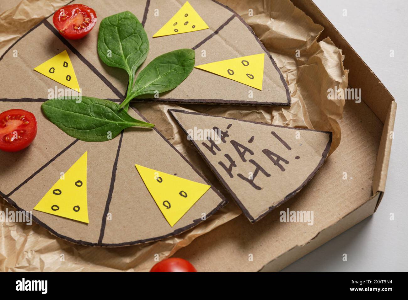 Carton pizza with tomatoes and basil on white background. April Fools ...
