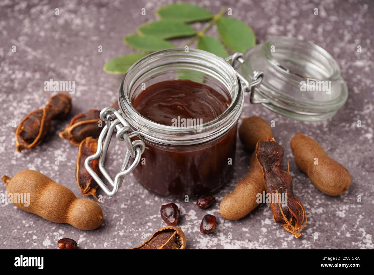 Jar with tasty tamarind jam and fruits on grey background Stock Photo ...