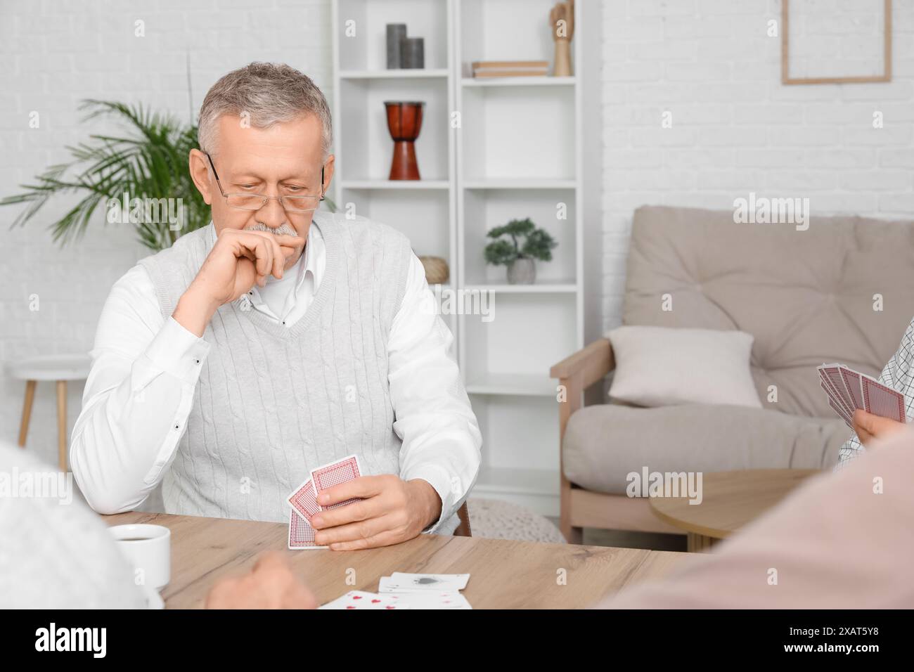 Mature friends playing cards hi-res stock photography and images - Alamy