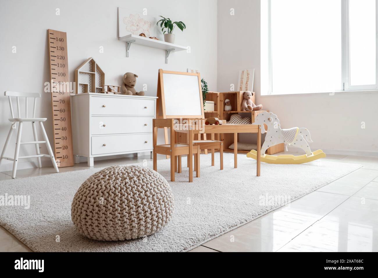 Interior of light playroom with toys and whiteboard in kindergarten ...