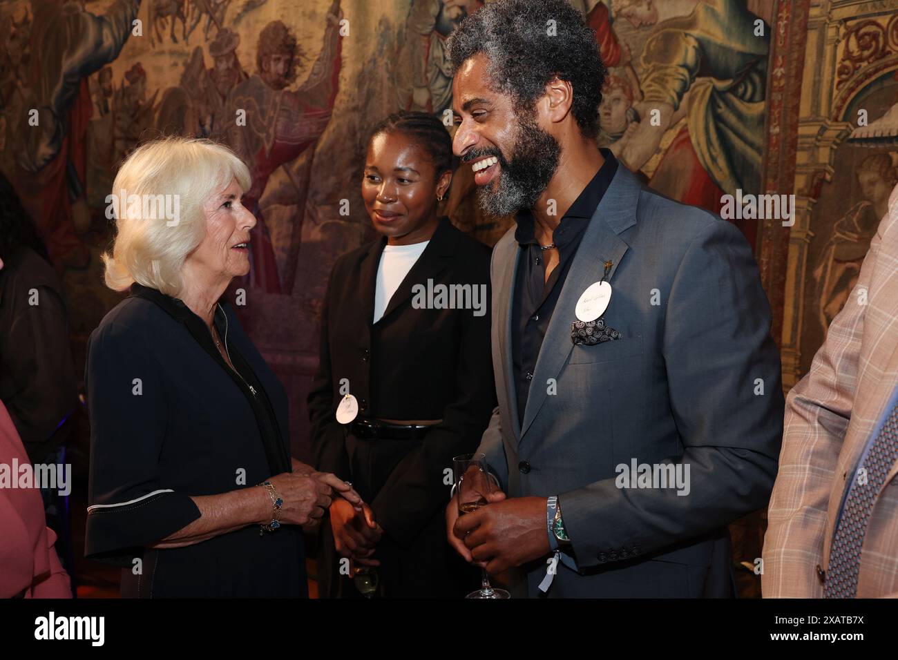 Queen Camilla speaks to Karl Collins during a reception with authors ...