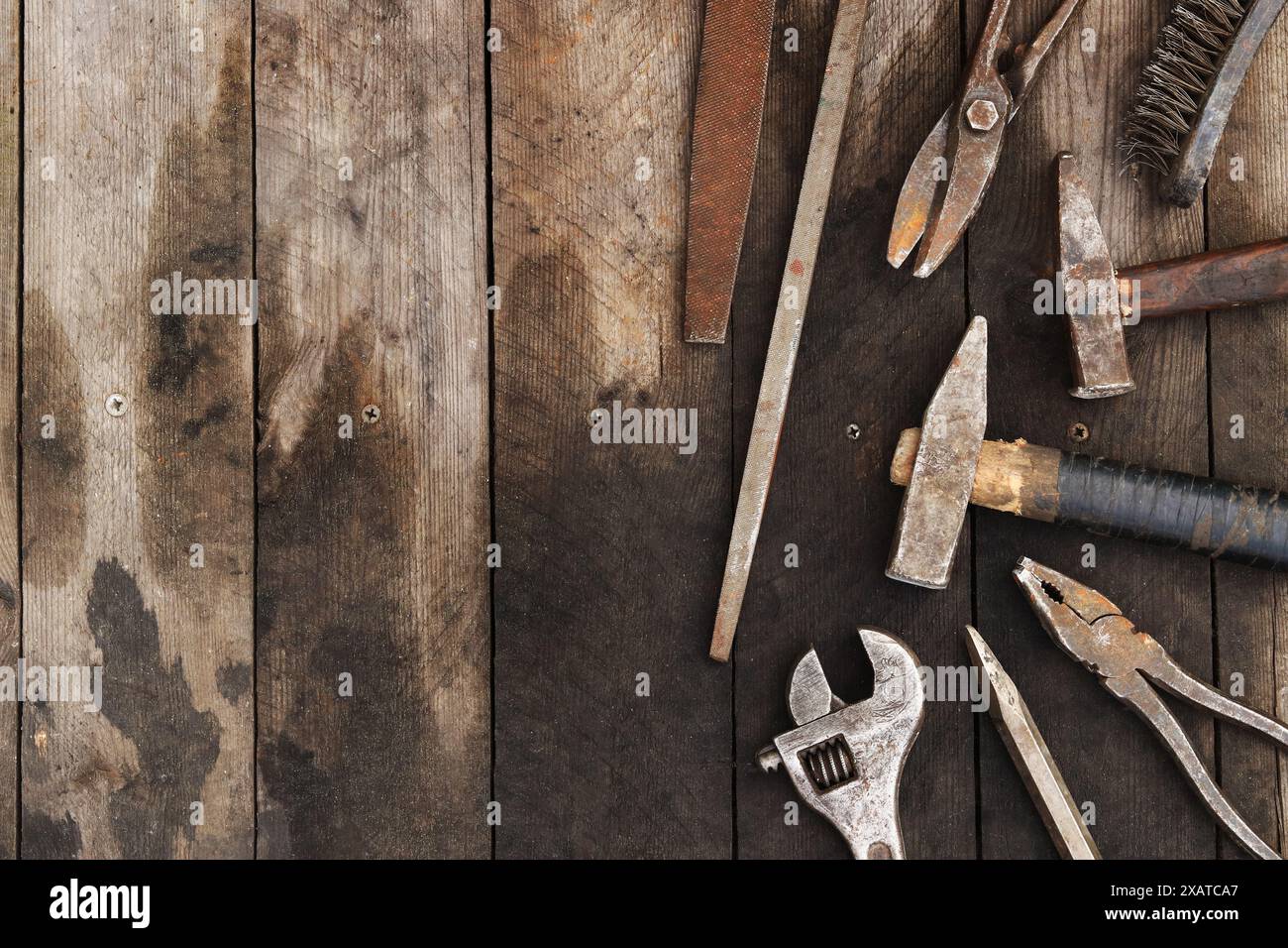 Old work tools on a plank wooden background, top view. Hammers, flat ...