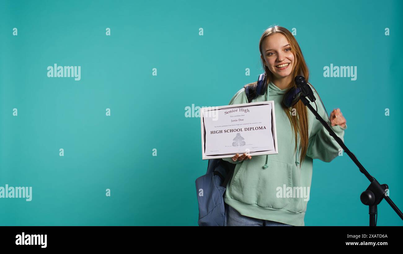 Happy student holding diploma talking in microphone, addressing ...