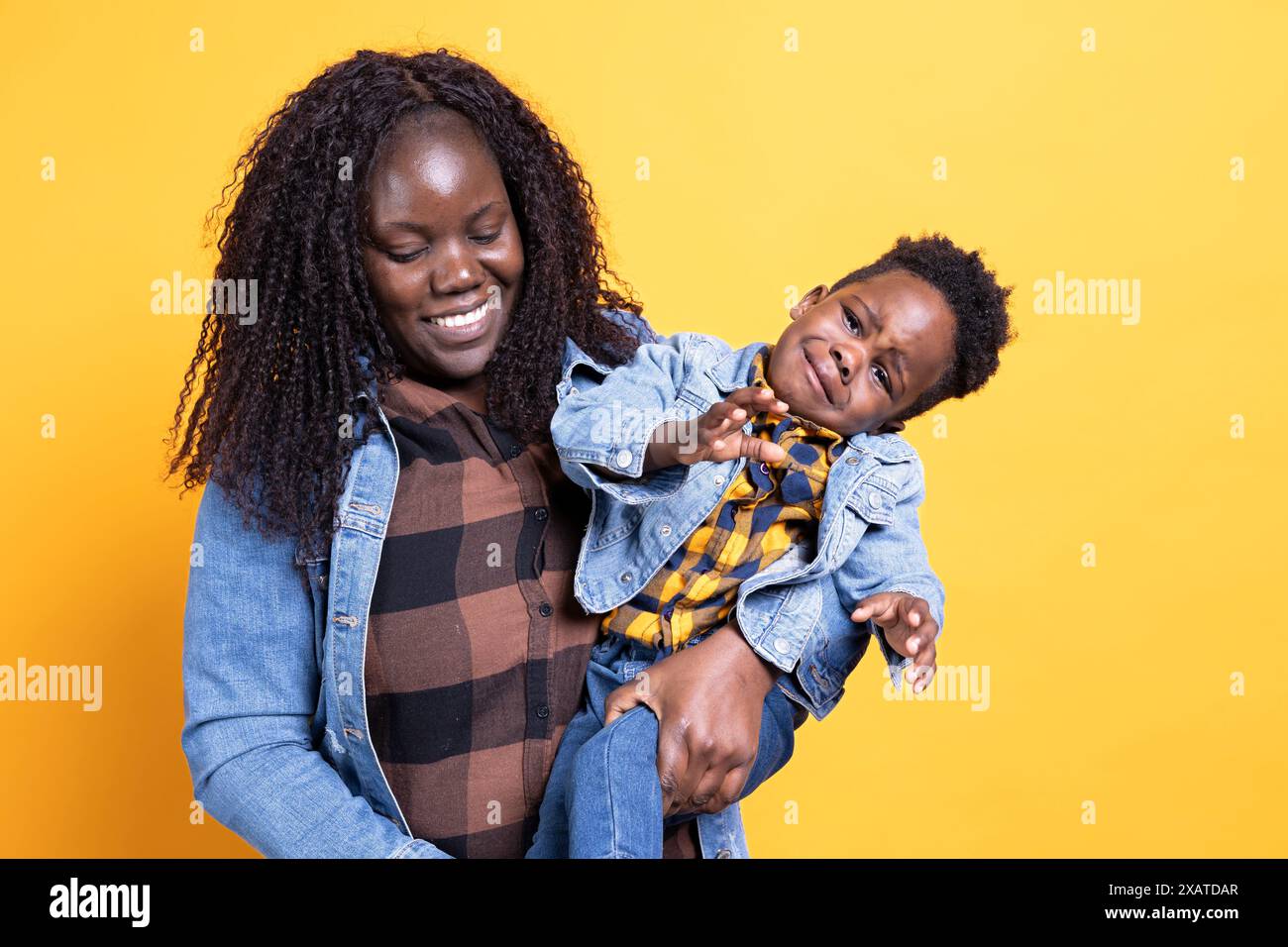Anxious agitated cute child starts crying against yellow background ...
