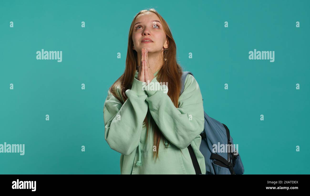 Hopeless young girl praying to deity for salvation. Religious teenager ...