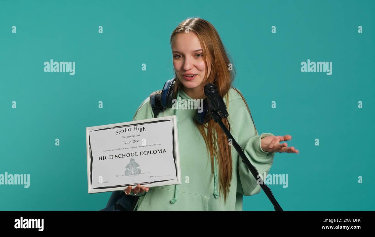 Happy student holding diploma talking in microphone, addressing ...