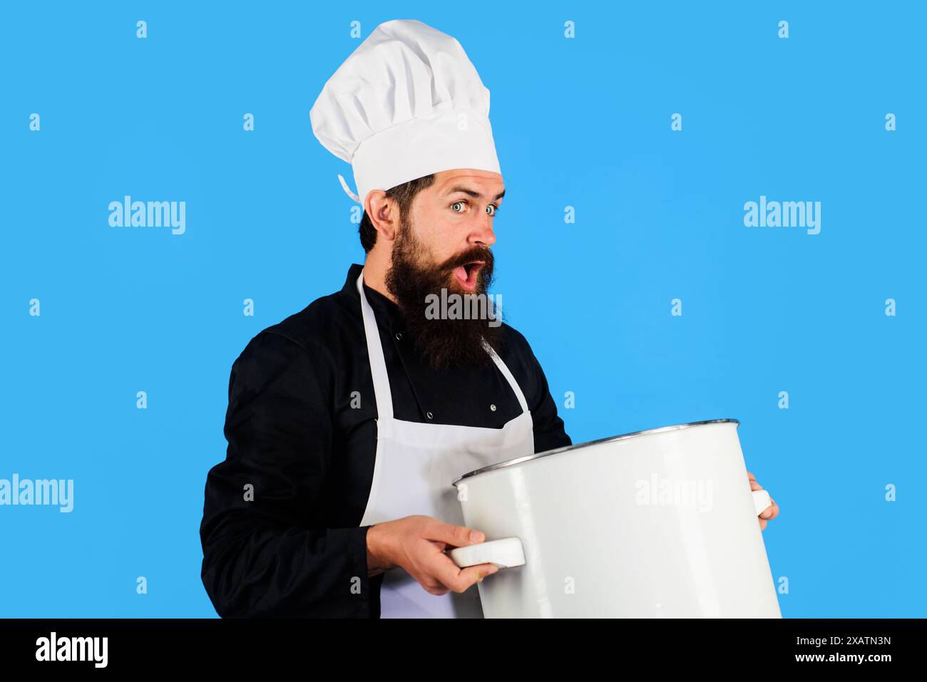 Professional chef with big cooking pot. Surprised male cook prepares ...