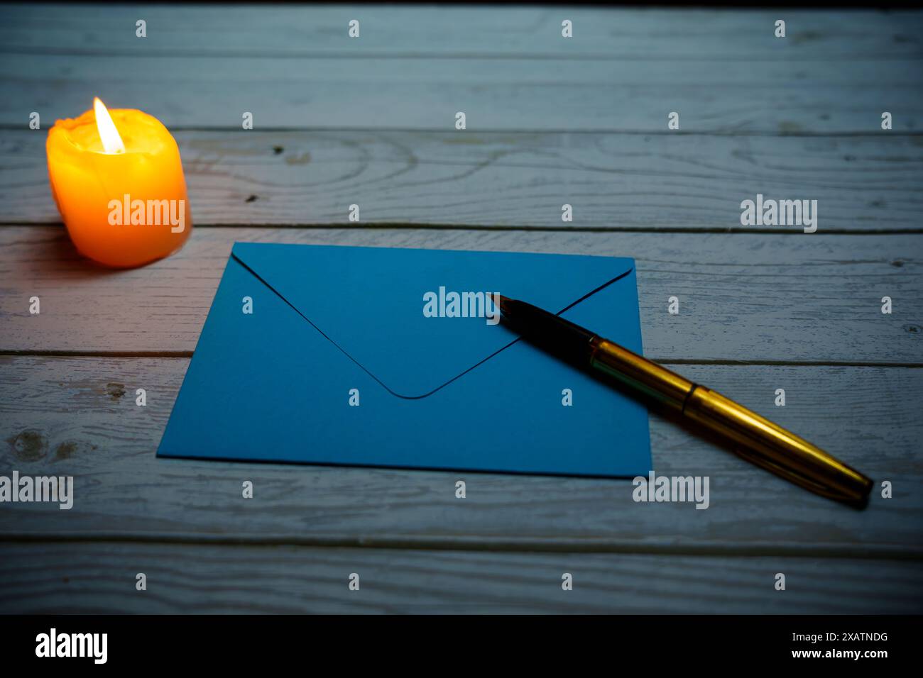 A blue envelope with a gold handle in the candlelight Stock Photo - Alamy