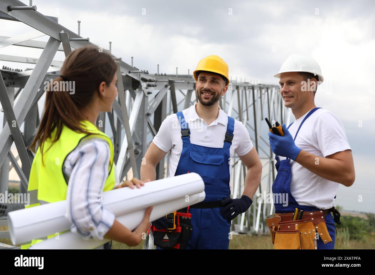 Professional engineers working on installation of electrical substation ...