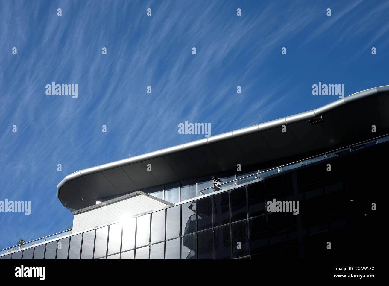 Soft wispy lines of cirrus clouds over a modern office building ...