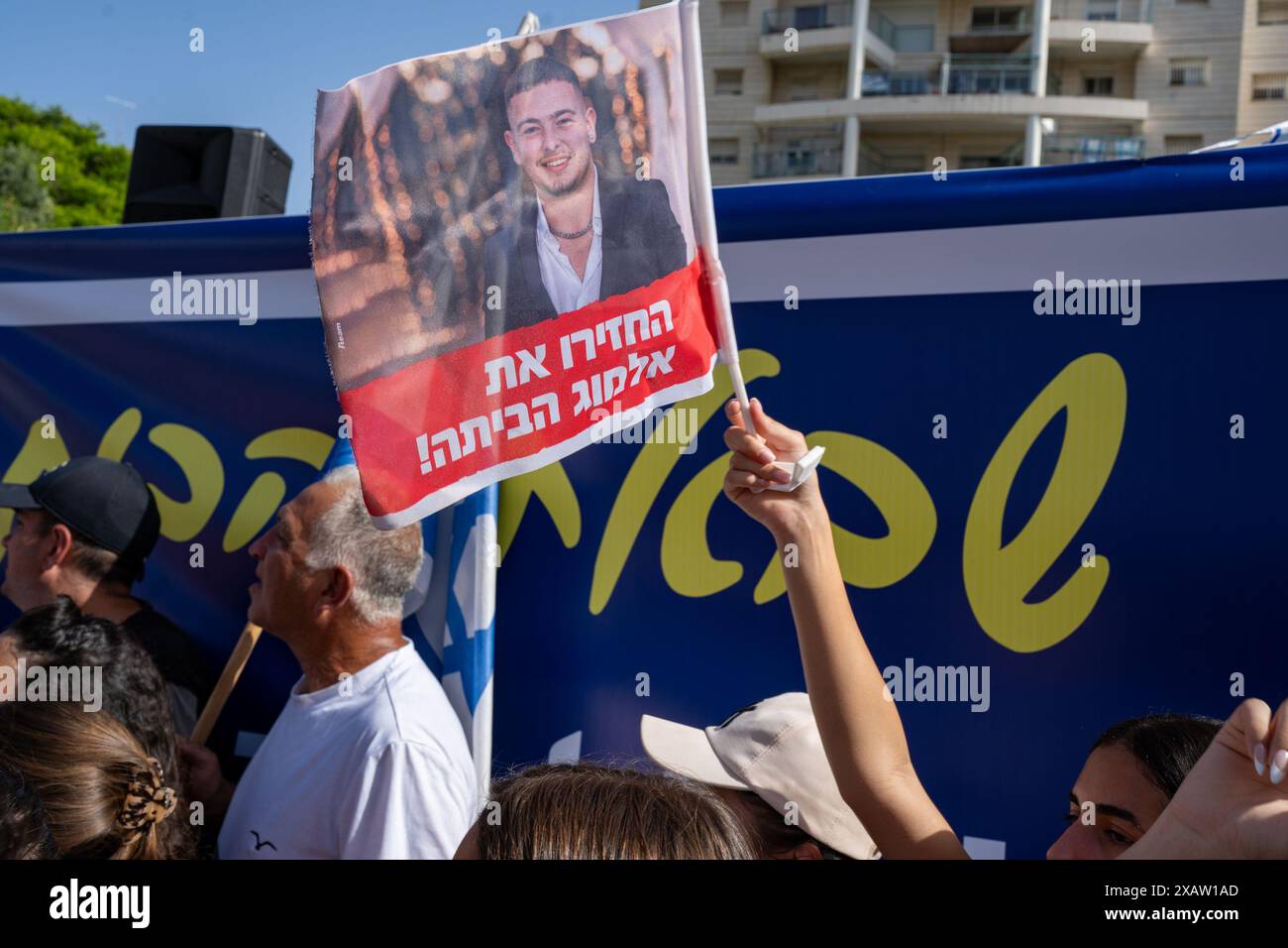 A flag waived with Almog Meir Jan's photo and the text "Bring Almog ...