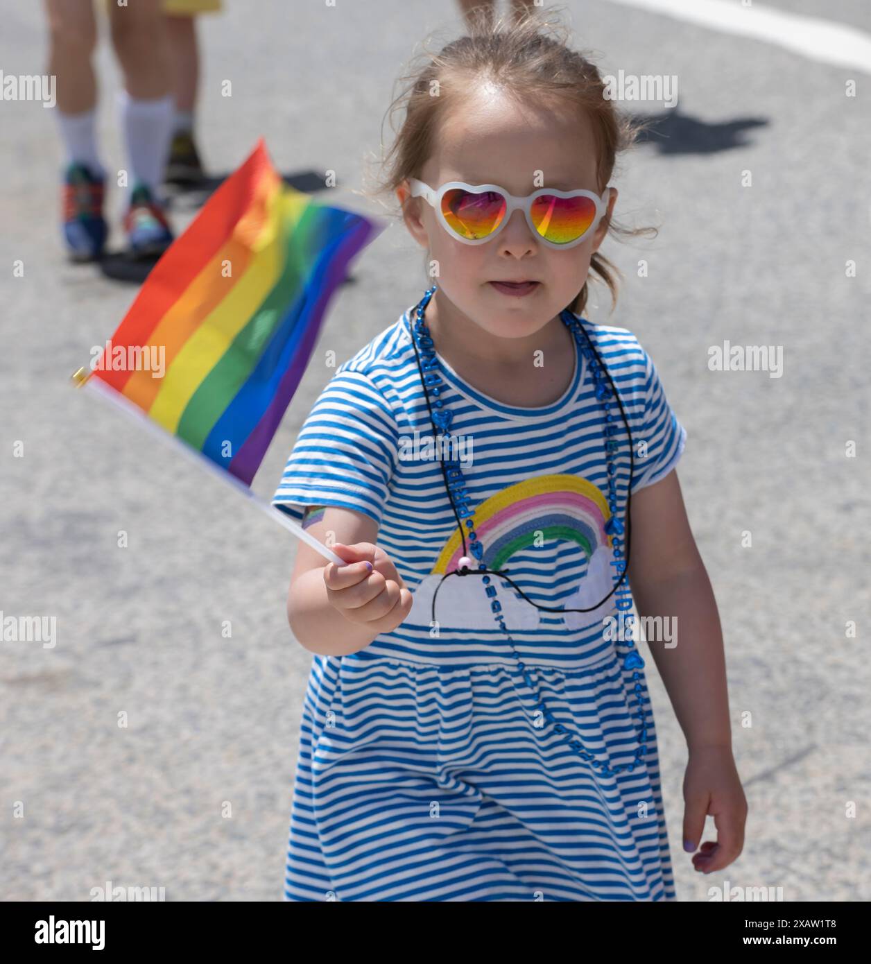 Boston, Massachusetts, USA June 8, 2024. Child waving the gay pride ...