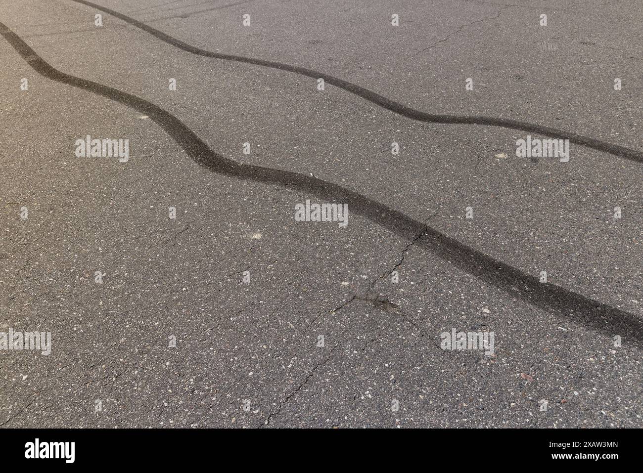 tire tracks during dangerous driving on the road , wheel streaks from ...