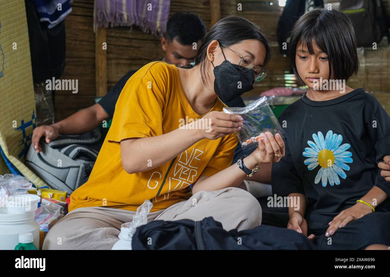 A civil disobedience movement's medical student seen explaining about the tablets to a patient ...