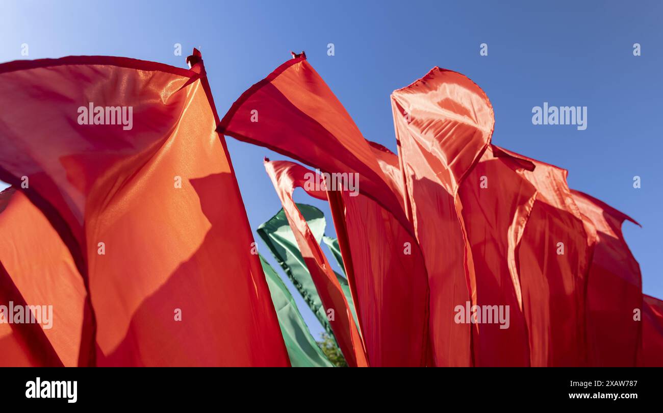 red flags set up during the celebration in windy weather, flags flutter ...
