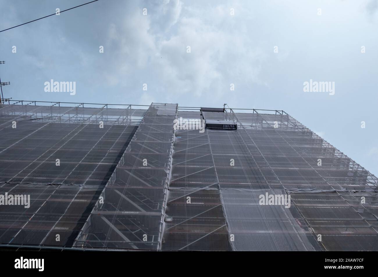 Renovation work. Safety in workplace, scaffolding with fall protection ...