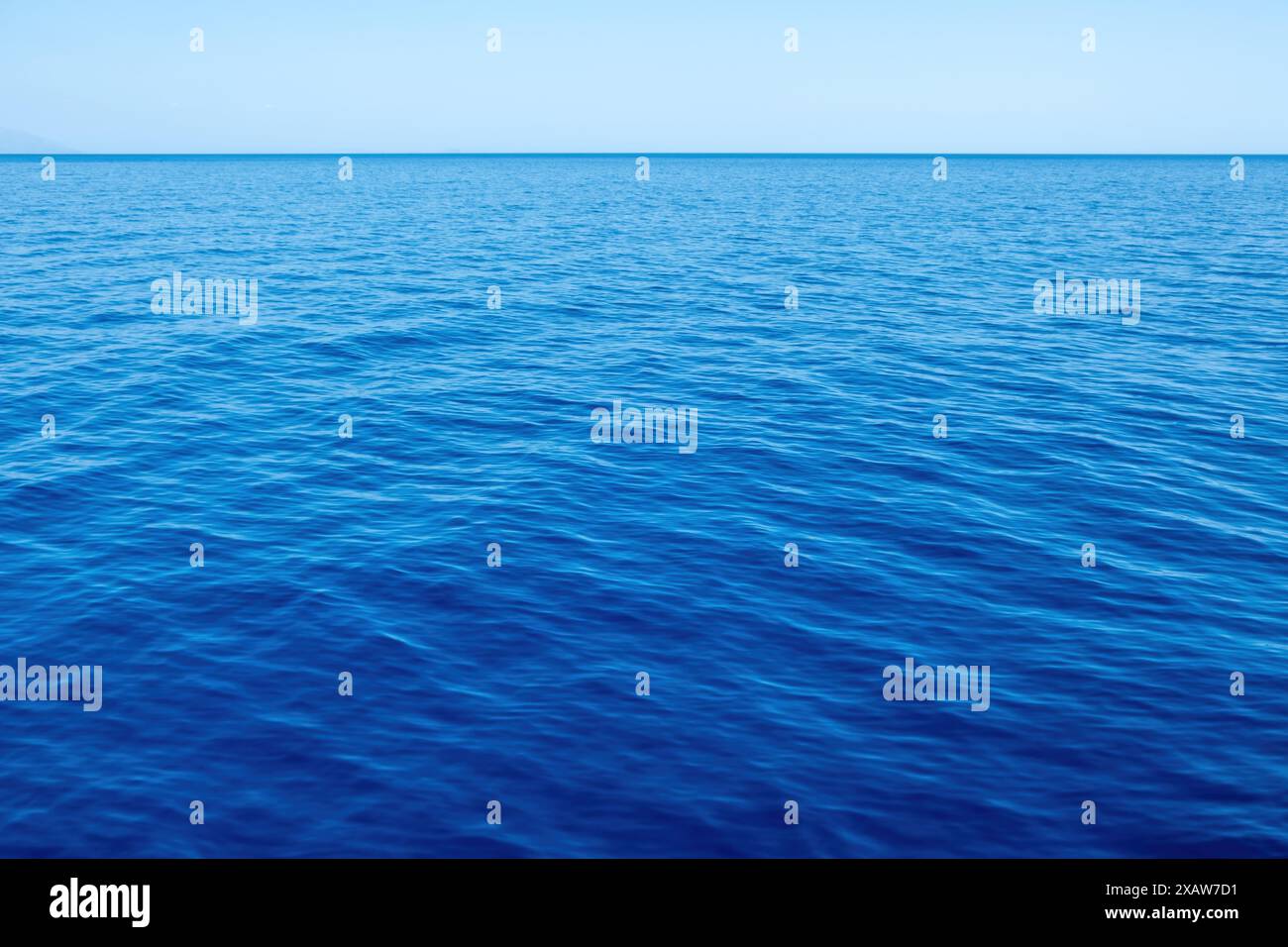 Ripple sea joins with blue sky background texture. Empty clear sea ...