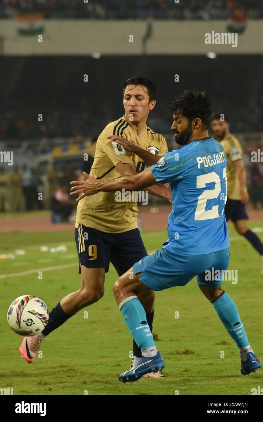 Nikhil Poojari #21 of India and Mohammad Daham #9 of Kuwait battle for the ball during the FIFA ...
