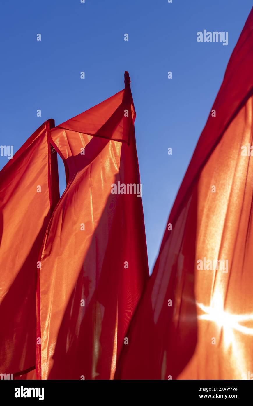 red flags set up during the celebration in windy weather, flags flutter ...