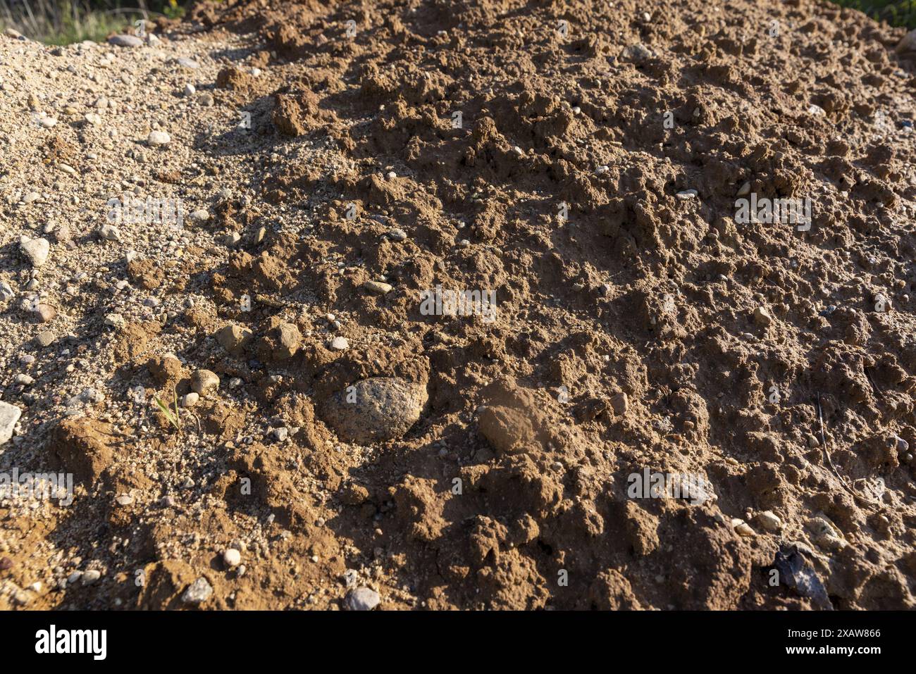 sand with stones that is used in the construction of facilities, a ...