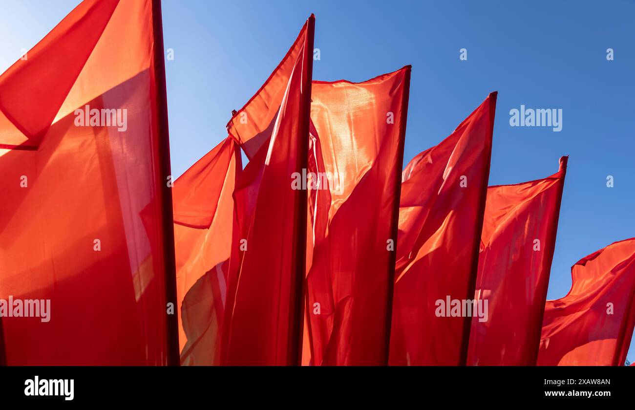 red flags set up during the celebration in windy weather, flags flutter ...