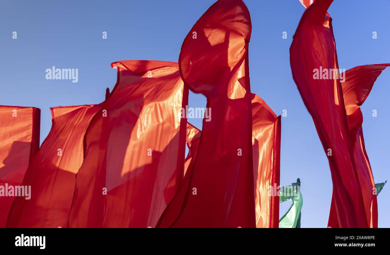 red flags set up during the celebration in windy weather, flags flutter ...