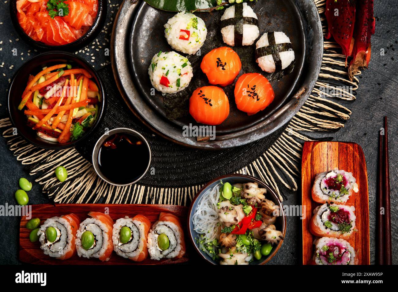 Sushi and japanese food on a dark background. Sushi rolls, soup, fried ...